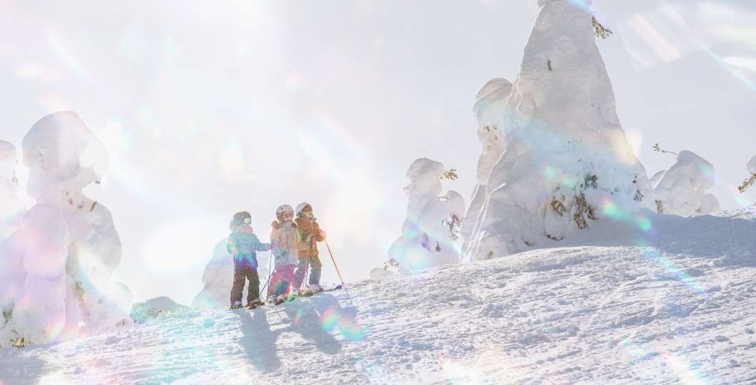 Kids next to snow covered trees in Ruka